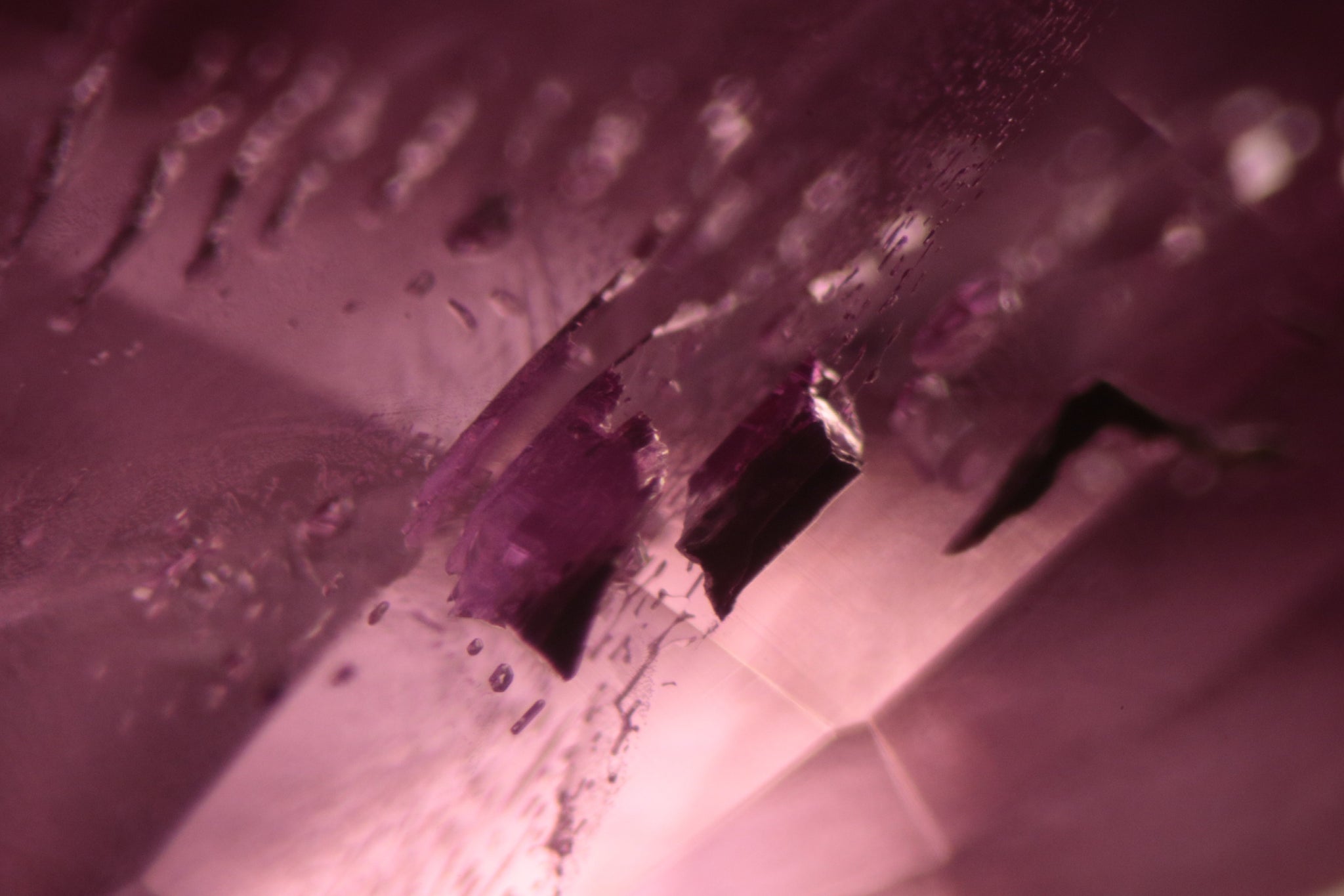 Crystal Inclusions and Iron-Strain Features in Natural Pink Sapphire
